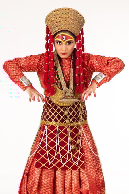 A beautiful girl dressed as Goddess Kumari in a dancing pose - Photos Nepal