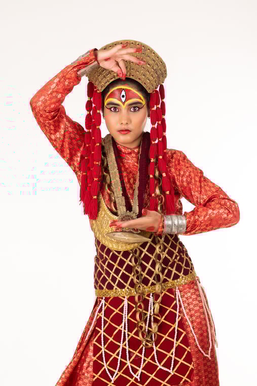 A beautiful girl dressed as Goddess Kumari in a dancing pose - Photos Nepal