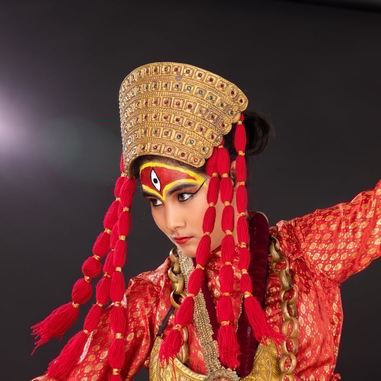 A beautiful girl dressed as Goddess Kumari in dancing pose - Photos Nepal