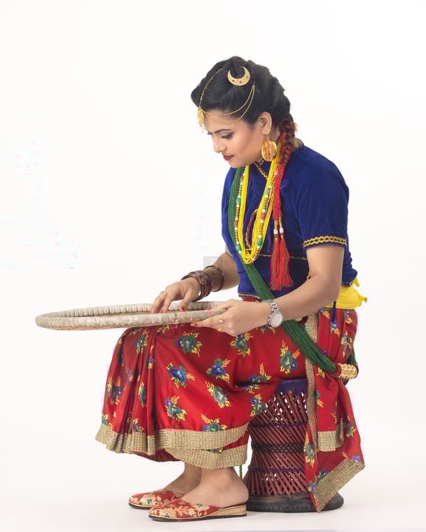 A beautiful girl shifting through rice grain - Photos Nepal