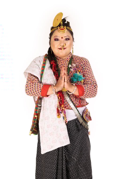 A beautiful lady in Magar dress doing Namaste in front of camera ...