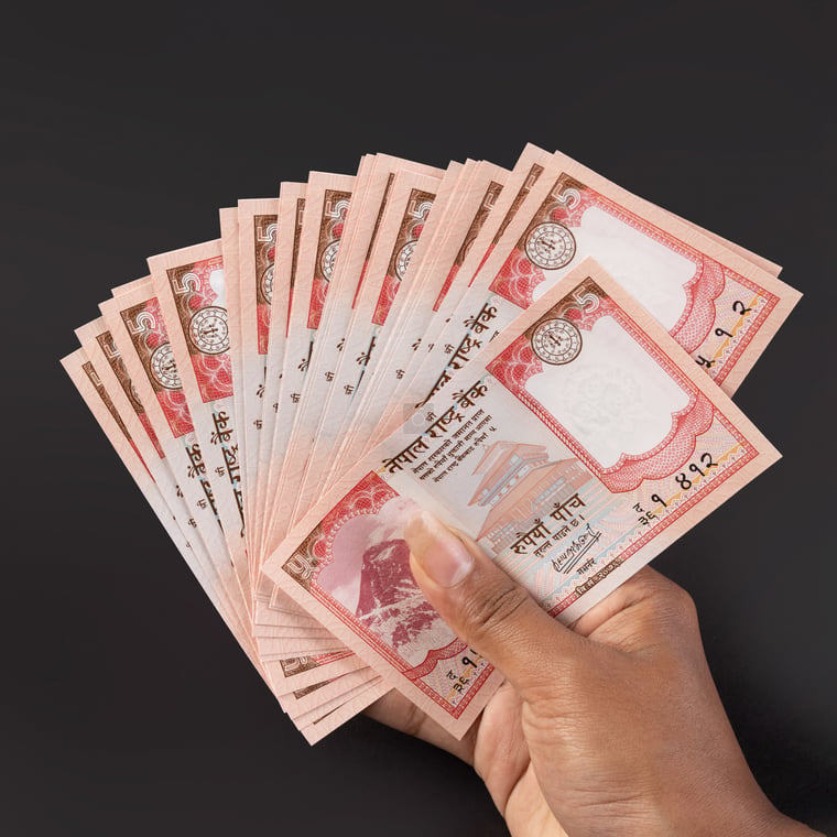 A bundle of banknotes of Rs 5 in a spread - Photos Nepal