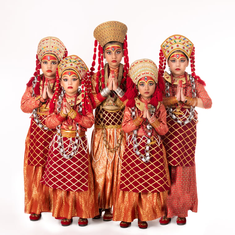 A group of little girls dressed as Goddess Kumari doing Namaste ...