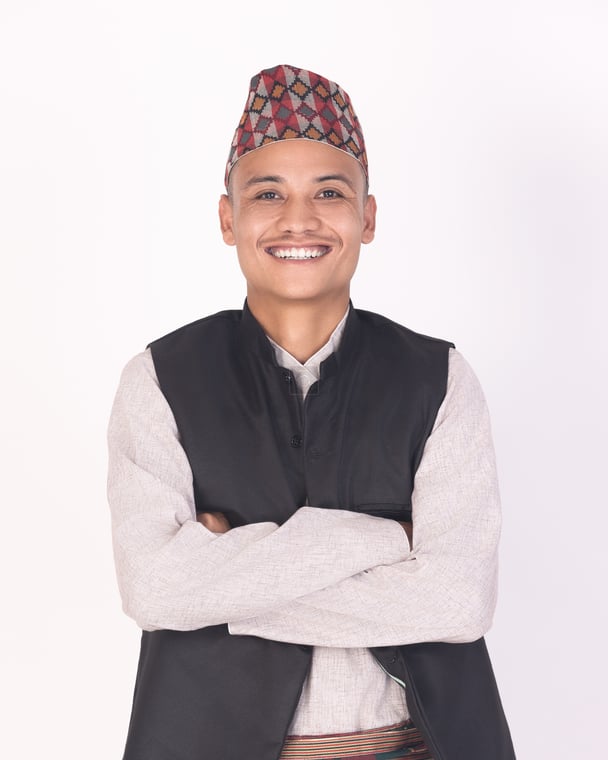 A handsome guy in Daura Suruwal smiling with crossed arms - Photos Nepal
