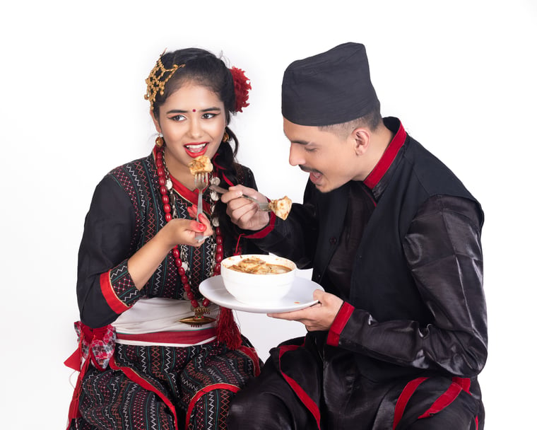 A Newari couple enjoying a bowl of momos - Photos Nepal