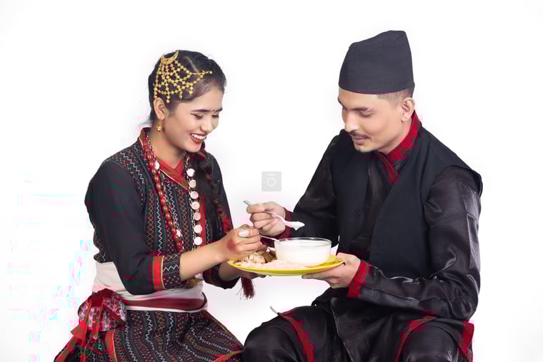 A Newari couple share a bowl of Dahi Chiura together - Photos Nepal