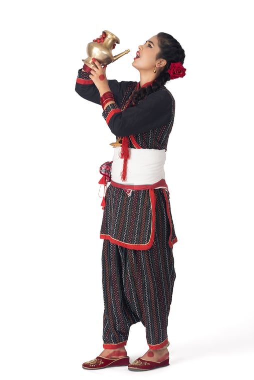 A Newari girl drinking from a bronze Karuwa - Photos Nepal