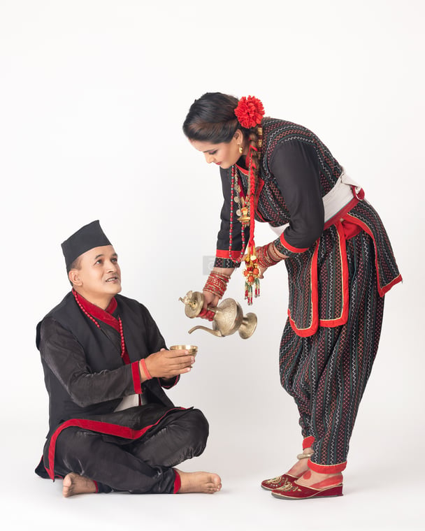 A caring Newari woman giving water - Photos Nepal