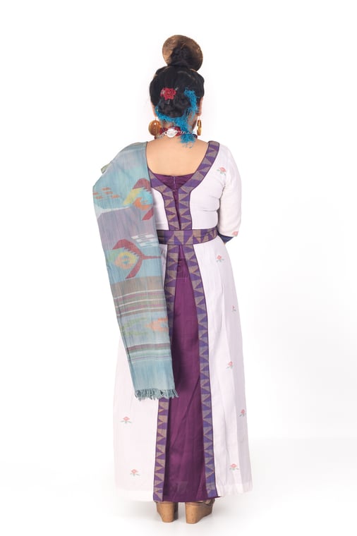 A Limbu woman wearing Limbu Dhaka dress turns her back to the camera ...