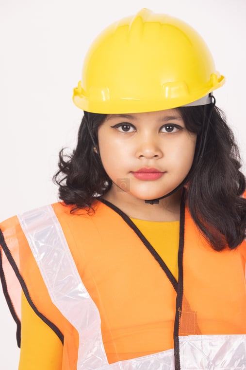 A little young engineer girl with construction worker dress set up ...