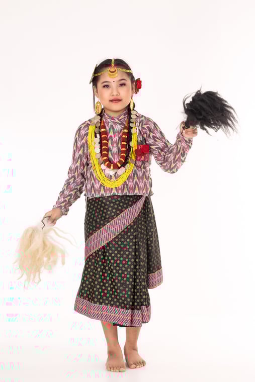 A pretty child with traditional Dhaka cloths holding Chamar - Photos Nepal