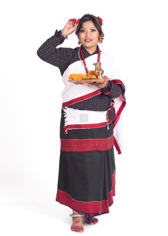 A religious Newari woman holding puja thali while wearing Newari outfit ...