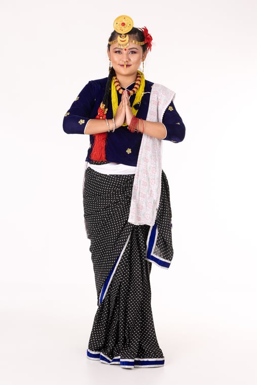 A smiling woman with traditional Rai clothes doing Namaste - Photos Nepal