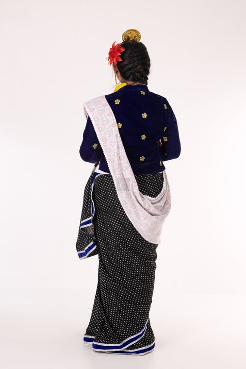 A tall woman dressed in traditional Rai apparel turns her back on the ...