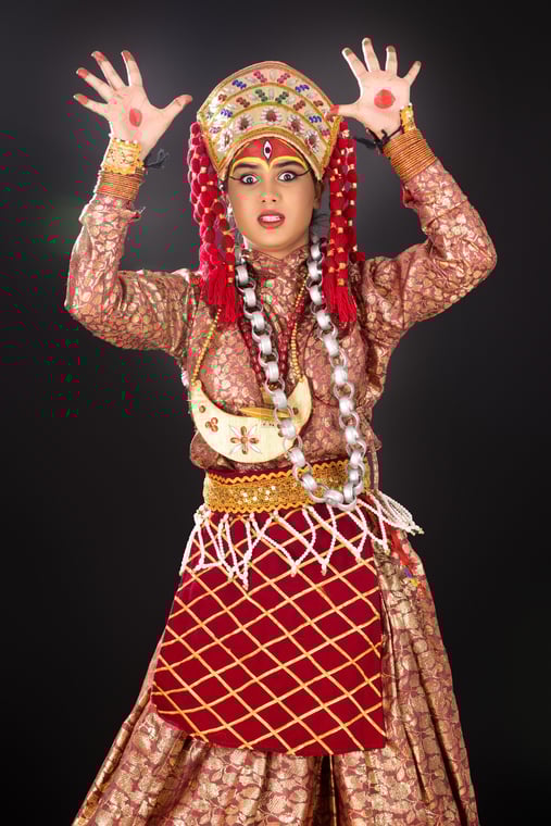 A young girl portraying the Living Goddess Kumari displays a frightened ...