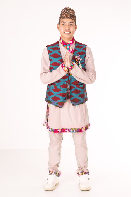 Cheerful boy in a Nepali traditional avatar giving Namaste salutations ...