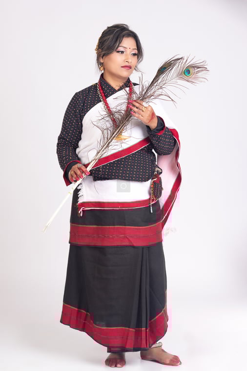 The eye-catching Newari woman is holding a peacock feather. - Photos Nepal