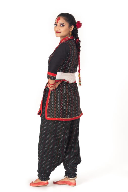 A traditional Newari girl posing sideways while placing hands on waist ...