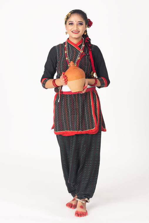 An encouraging, happy Newari girl with traditional Newari outfit holds ...