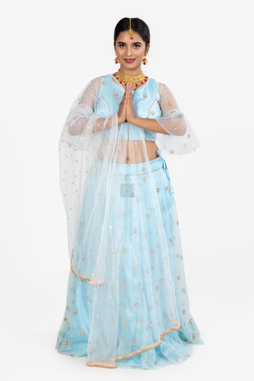 Beautiful Nepali Girl Doing Namaste in Light Blue Lehenga and Golden ...