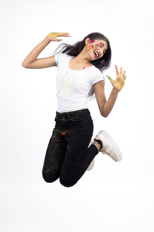 Celebrating Holi: Indian Girl Jumping with Joy - Photos Nepal