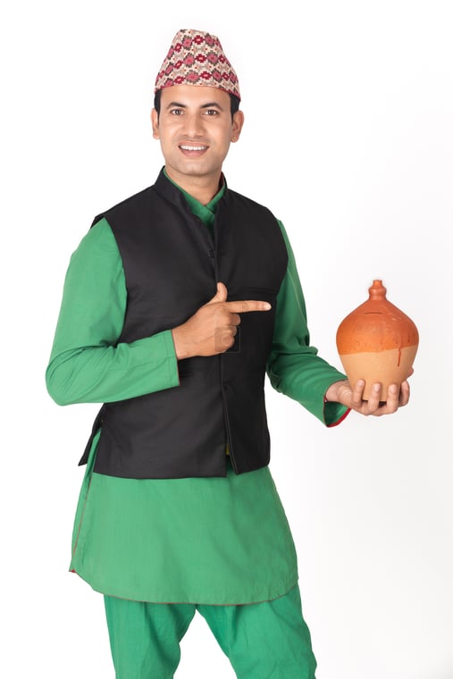 Nepali Man in Traditional Attire Holding Khutruke and Gullak, Looking ...
