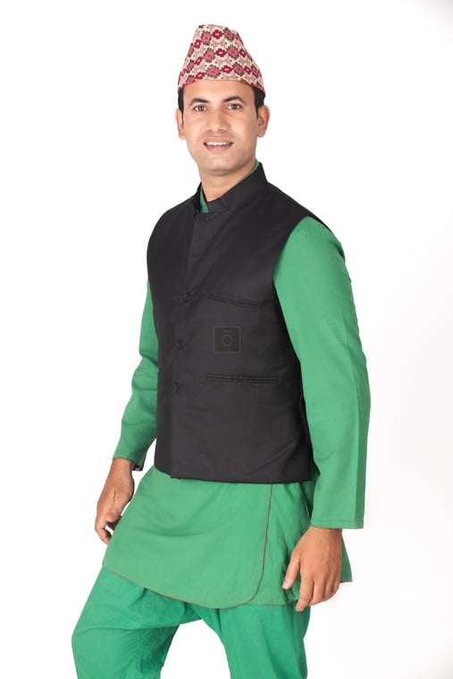 Nepali man in traditional dress confidently looking at camera in mid ...