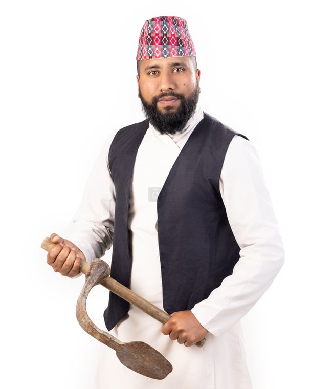 Nepali Man in Traditional Dress Holding a Kodali - Photos Nepal