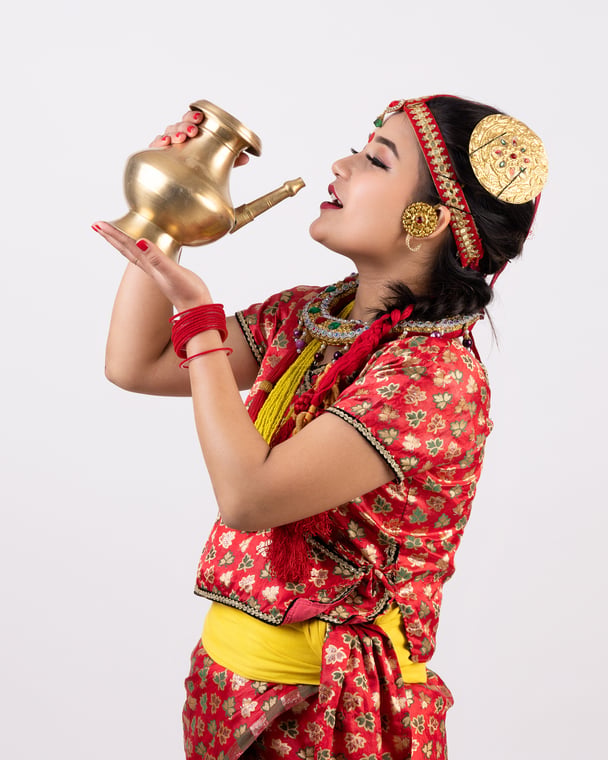 Nepali Woman in Traditional Dress Drinking Water from Karuwa - Photos Nepal