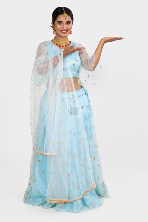 Smiling Nepali Girl in Light Blue Lehenga Showing Right - Photos Nepal