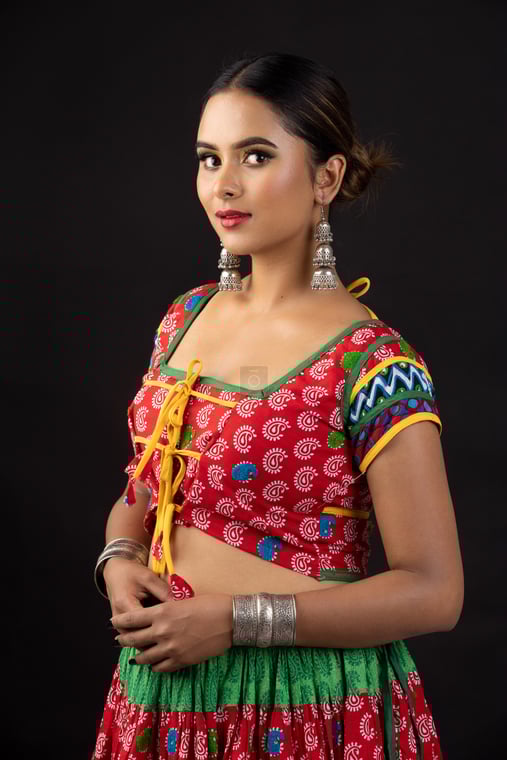 Tharu Girl in Cultural Regalia Looking into the Camera - Photos Nepal