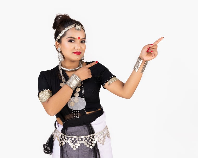 Tharu Girl in Tharu Dress Pointing Left with Index Fingers - Photos Nepal