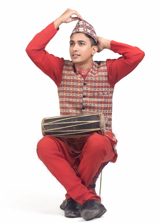 Boy adjusting Topi or Hat with Madal in Nepali dress - Photos Nepal