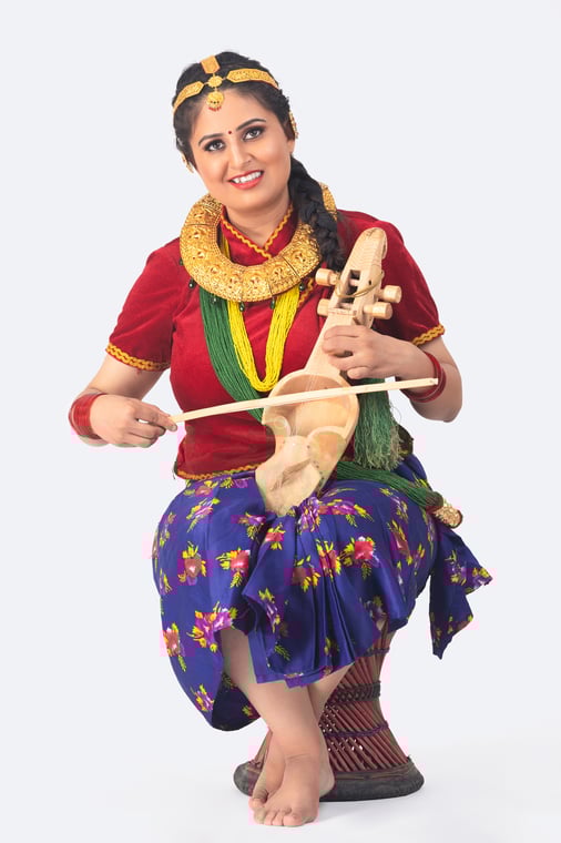 Traditionally dressed Nepali woman playing Sarangi - Photos Nepal