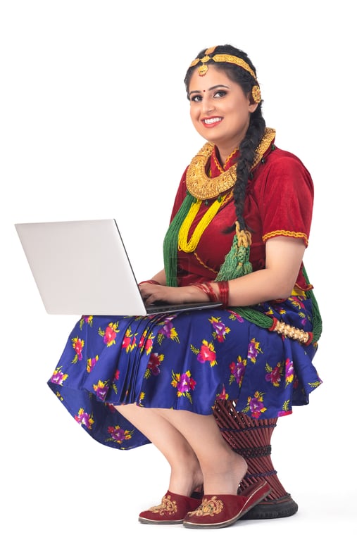 Traditionally dressed Nepali woman using her laptop - Photos Nepal