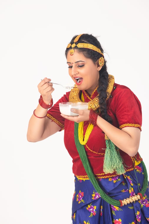 Traditionally dressed Nepali women having Dahi - Photos Nepal