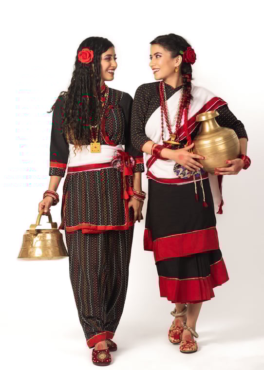 Two beautiful Newari girls carrying a water pot - Photos Nepal
