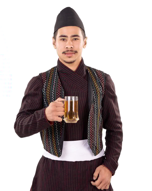 Handsome Newari man holding a glass of beer - isolated studio portrait ...