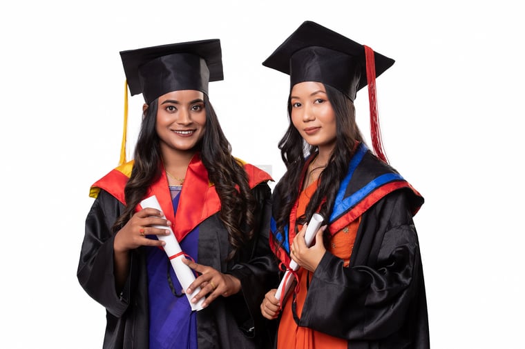 Diploma degree certificate in hand: two women in graduation gowns and ...