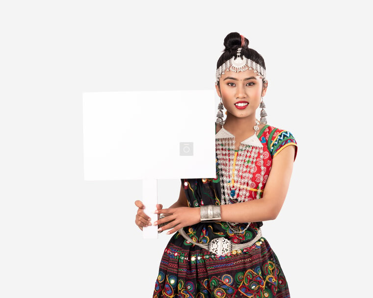 Photo of Tharu woman in Tharu dress holding a sign - Photos Nepal