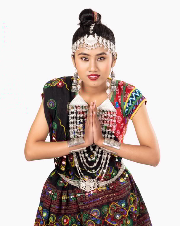 Tharu Girl in Colorful Lehenga Choli Performing Namaste Pose - Photos Nepal